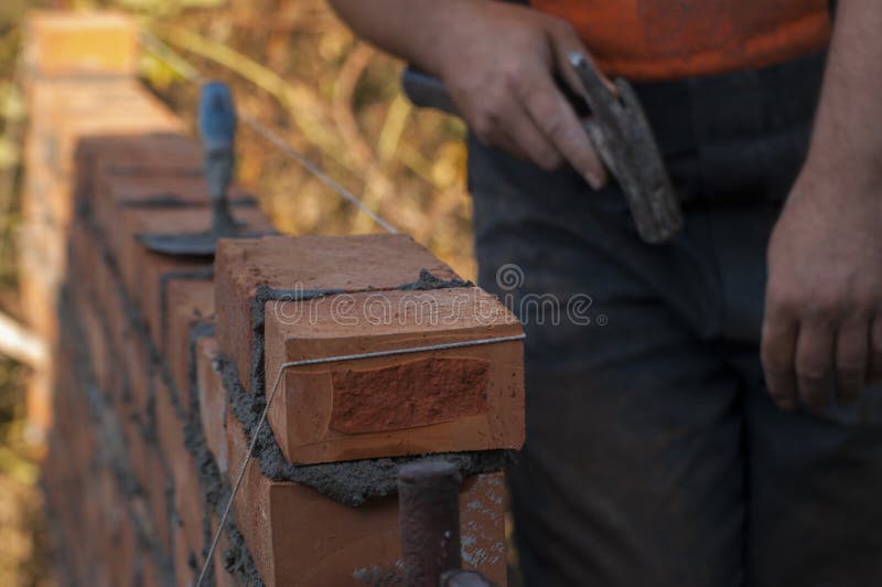Building a Wall with Red Brick. Working with Bricks for Building a Wall ...