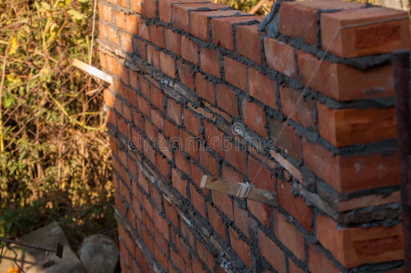 Building a Wall with Red Brick. Working with Bricks for Building a Wall ...