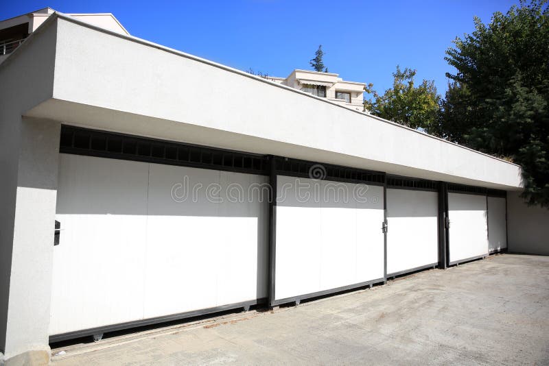 Building with White Automatic Garage Doors in City Stock Image - Image ...