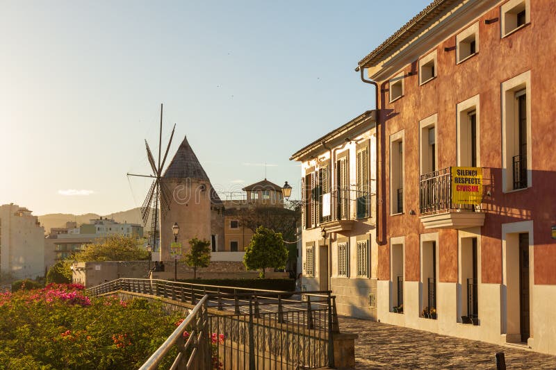 Building and a Windmill Stand Side by Side Stock Photo - Image of ...