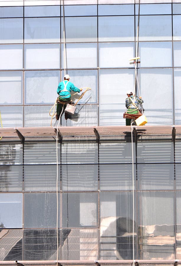 High Rise Window Cleaning Worker Cleans an Office Building Stock Photo ...