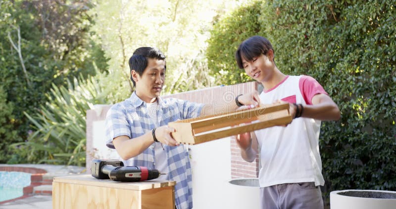 Building Wooden Project, Asian Father and Son Collaborating and Using Drill Outdoors Stock ...