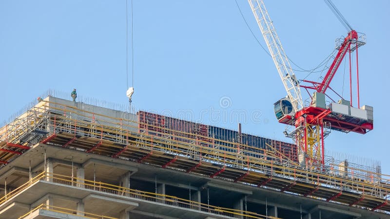 Building Workers and Red Crane on the Construction Site. Stock Image ...