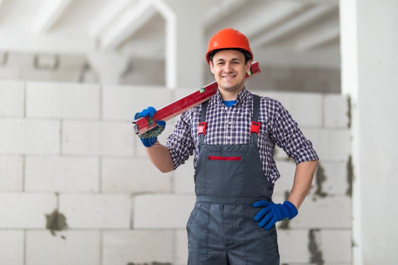 Building Young Worker Measuring the Wall with a Water Level at ...
