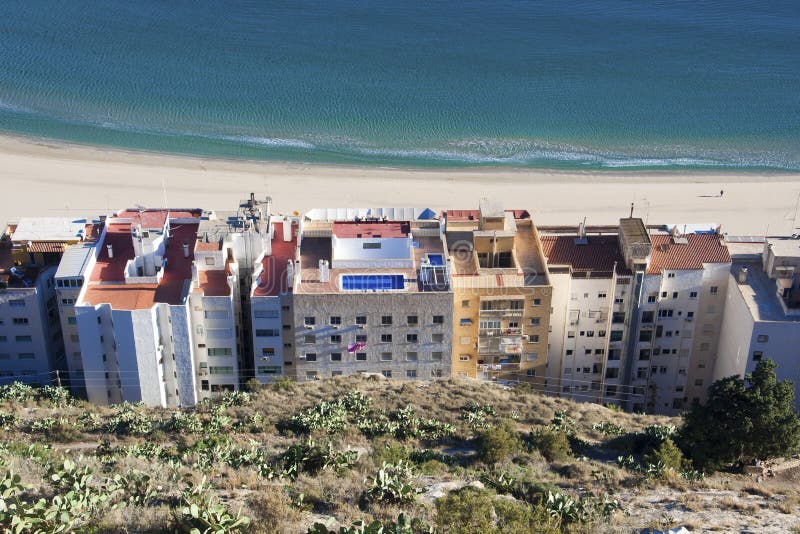 Buildings by beach and sea stock photo. Image of mediterranean - 18720668