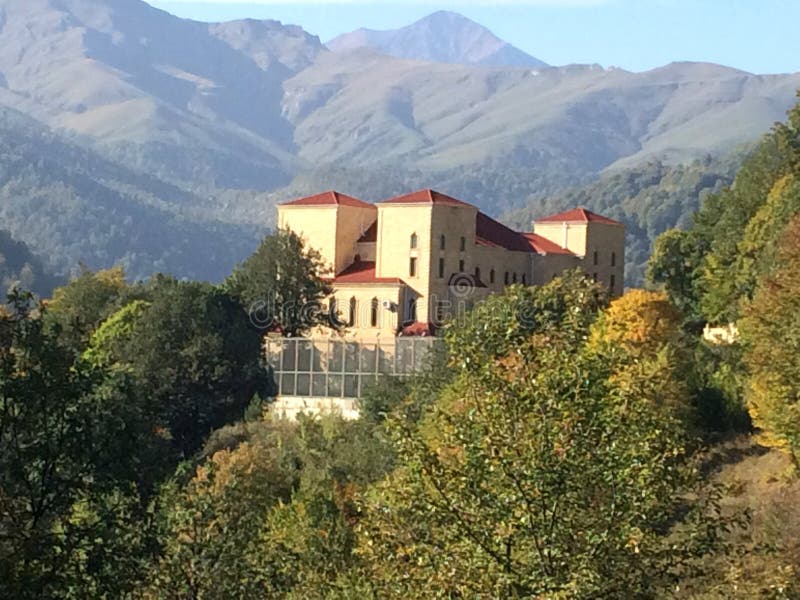 Buildings in Front of the Mountains, Inside the Forest Stock Photo ...