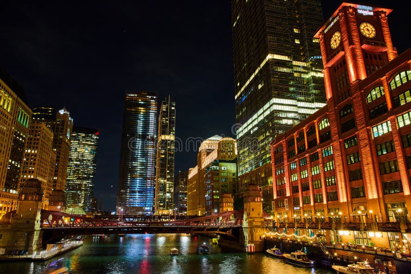 Buildings Light Up at Night Along Chicago Ship Canals with Bridge ...