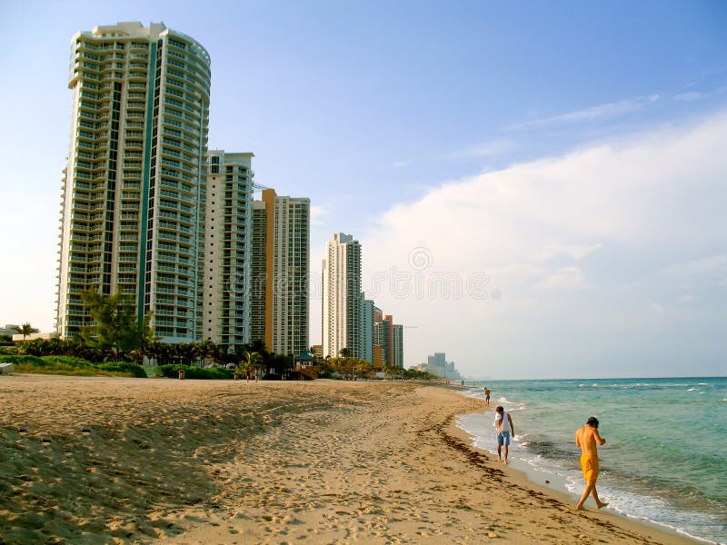 Buildings on Shore. Ocean. People Walk on the Beach Stock Image - Image ...