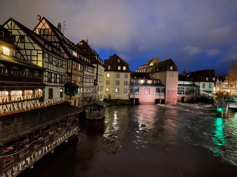 On the Shore of a River at Nightfall with Clouds in the Background ...