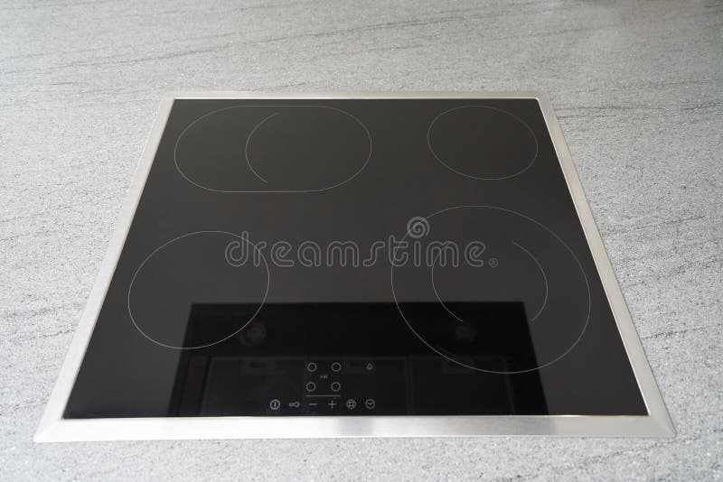 Built-in Induction Cooker with a Black Glass Surface in the Kitchen ...