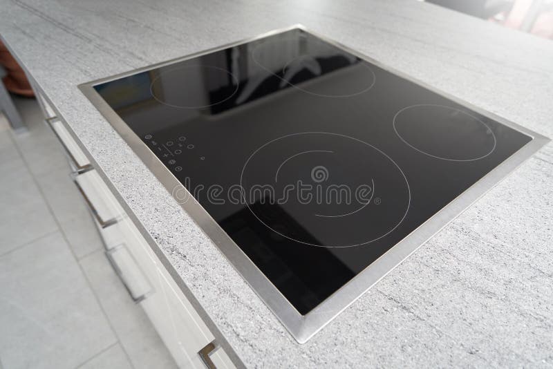 Built-in Induction Cooker with a Black Glass Surface in the Kitchen ...