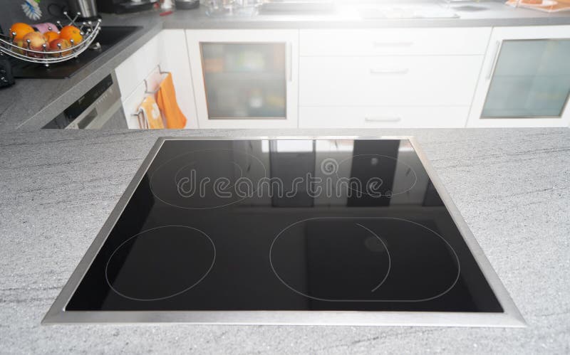 Built-in Induction Cooker with a Black Glass Surface in the Kitchen ...