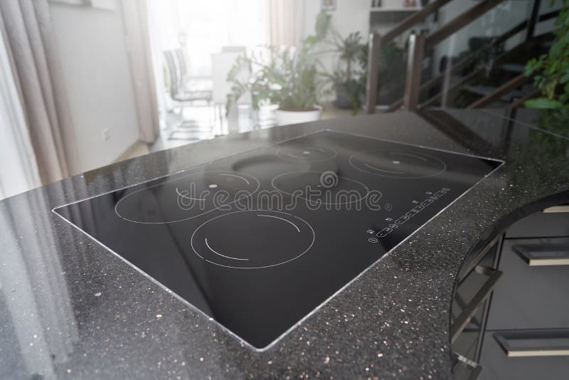 Modern Induction Cooker with a Black Glass Surface and Integrated Hood ...