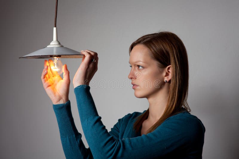 Woman Changing Lightbulb Studio Stock Photos - Free & Royalty-Free ...