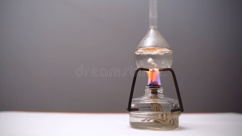 Bulb with Boiling Liquid on Burner Flame. Flask Heated on Burner in ...
