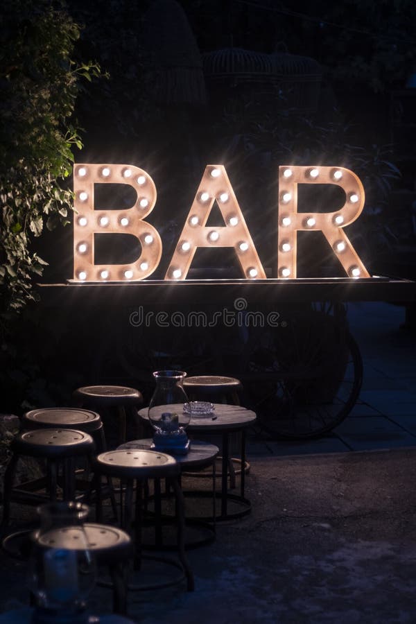 Bulb Lights Shaping BAR Word on a Pub Terrace on a Dark Evening Stock ...