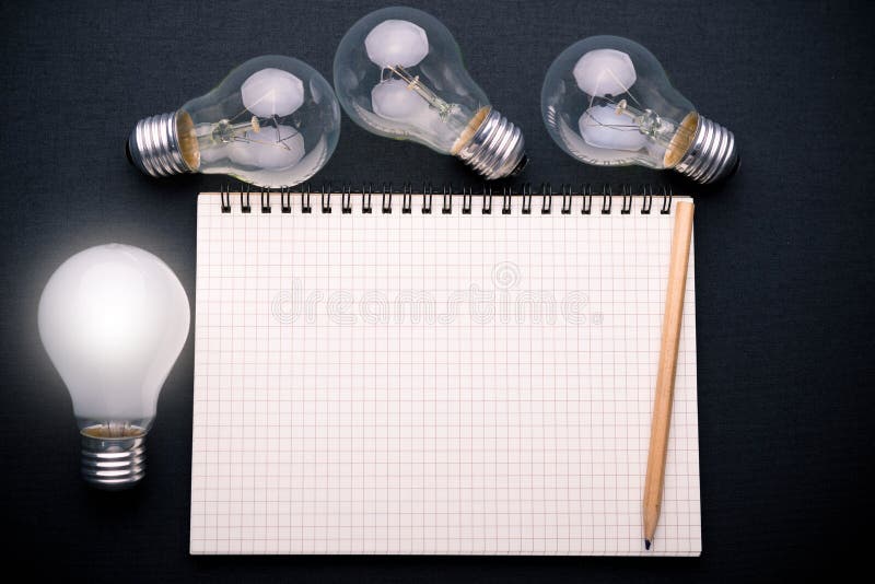 Bulb and notebook stock photo. Image of lamp, electricity - 85882320