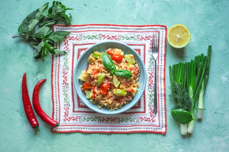 Bulgur with Vegetables in a Plate on a Green Kitchen Table. Stock Photo ...