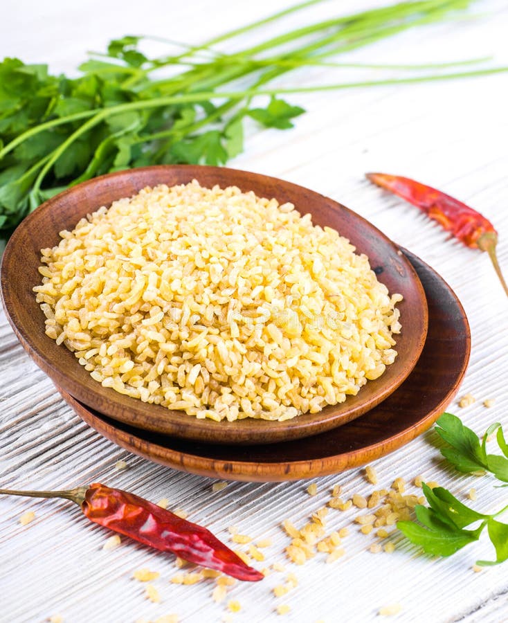 Bulgur in a wooden plate stock photo. Image of closeup - 39384332