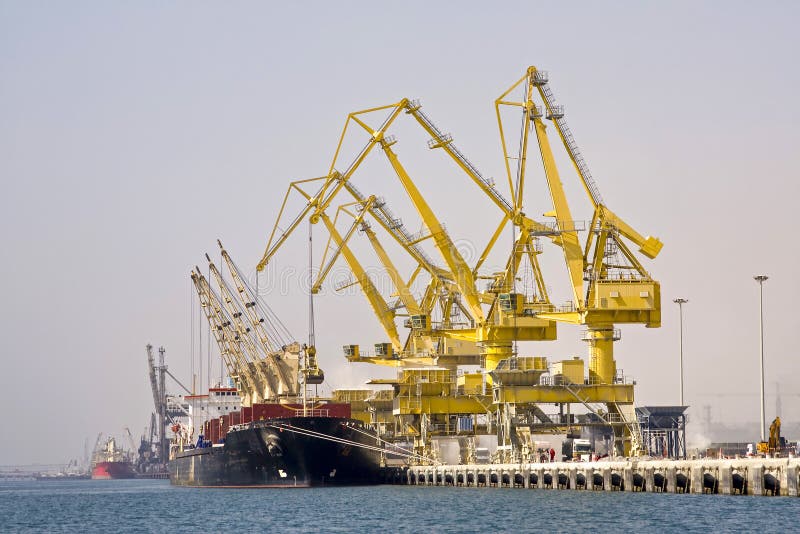 Bulk Cargo Ship Under Port Crane Bridge. Stock Photo - Image of load ...