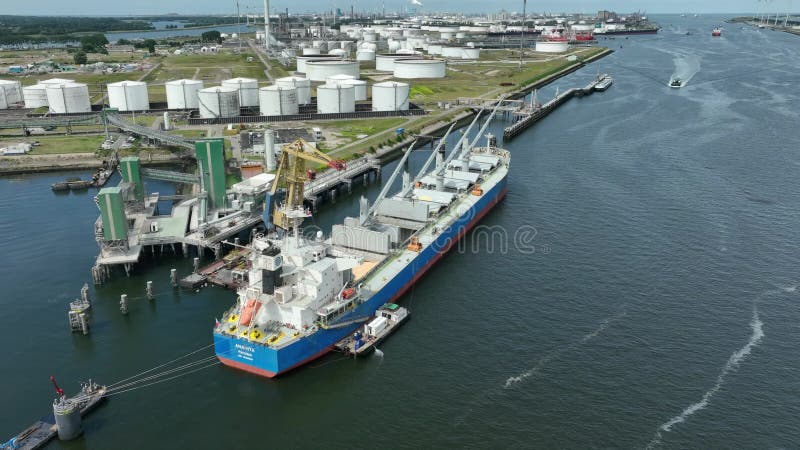 Bulk Carrier Ship at Port Offloading Cargo and Commodities by Shore ...