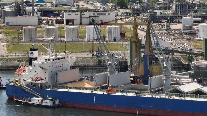 Bulk Carrier Ship at Port Offloading Cargo and Commodities by Shore ...