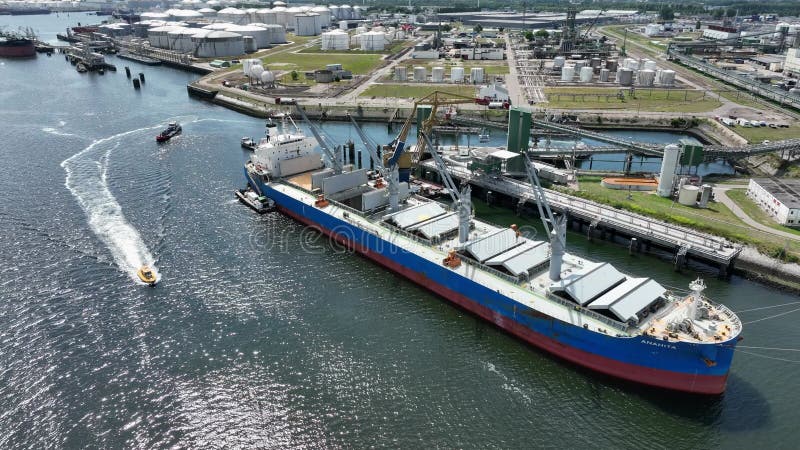 Bulk Carrier Ship at Port Offloading Cargo and Commodities by Shore ...