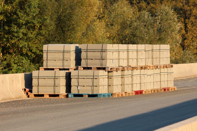 Bulk Stacks of Concrete Road Curbs on Pallets at Highway Project Stock ...