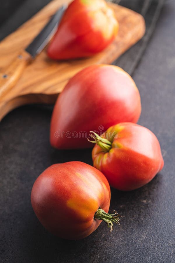 Bull Heart Tomatoes on Black Table Stock Photo - Image of nature, table ...
