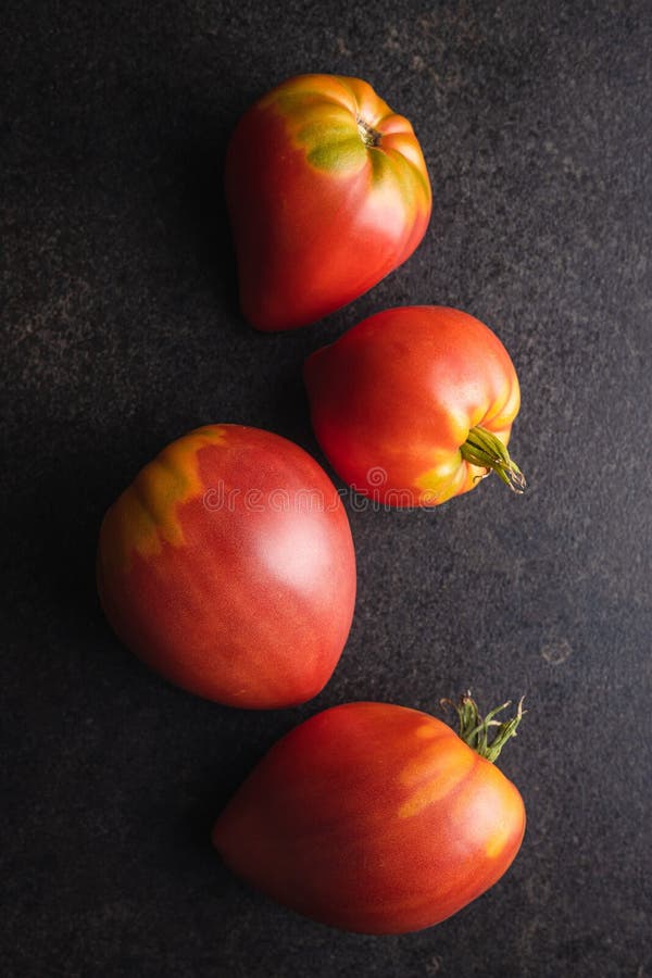 Bull Heart Tomatoes on Black Table Stock Photo - Image of flat, summer ...