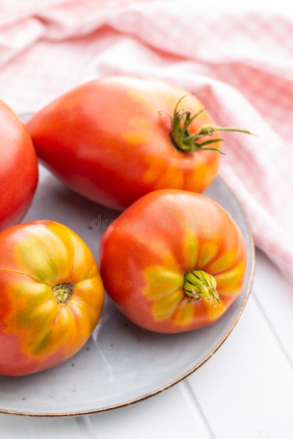 Bull Heart Tomatoes on Plate on White Table Stock Image - Image of ...