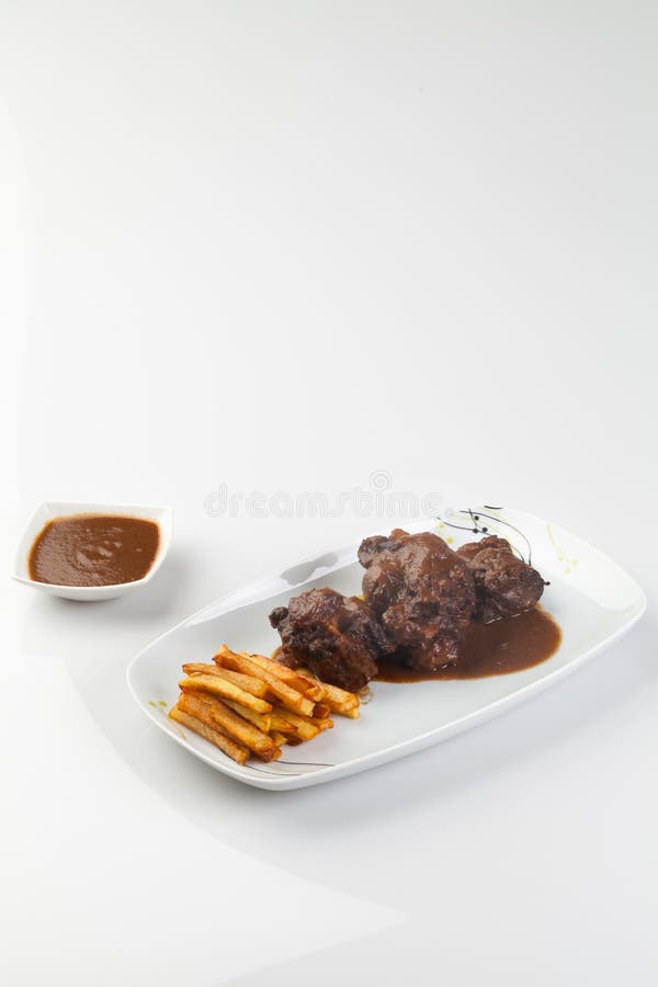 Bull Tail Dish with Fried Potatoes on White Table Stock Photo - Image ...