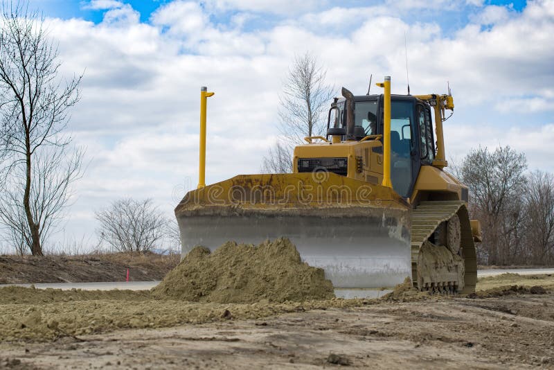 Bulldozed in road stock photo. Image of asphalt, bucket - 214848750