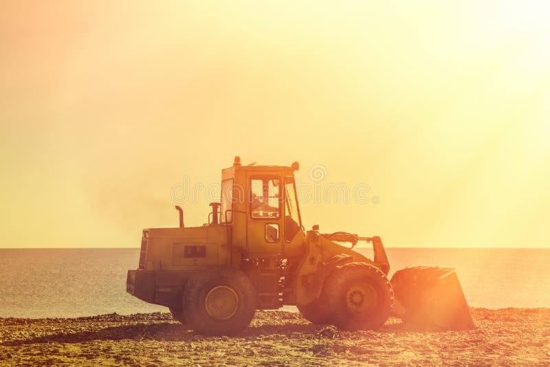 Bulldozer Against the Sea and Sunset Sky. Skyline. Tint. Copy Stock ...