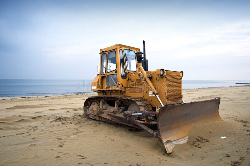 Bulldozer on the beach stock photo. Image of machine - 24528136