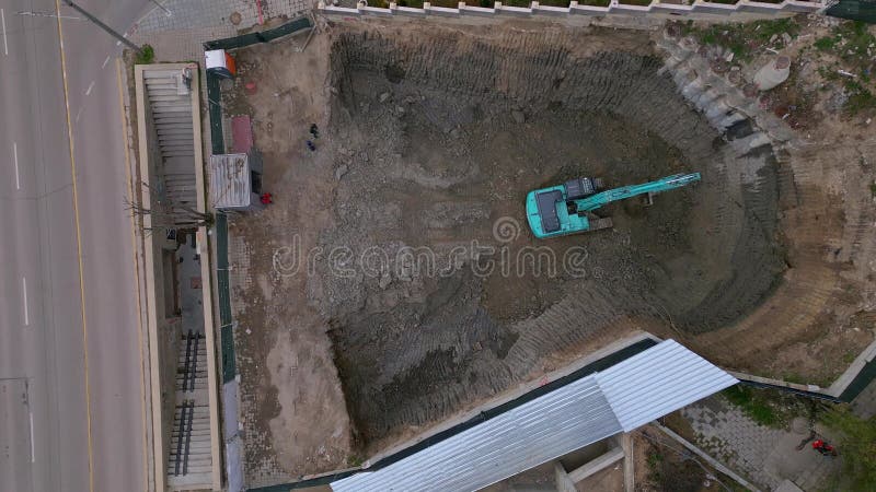 A Bulldozer is Digging a Pit for the Construction of Another Building ...