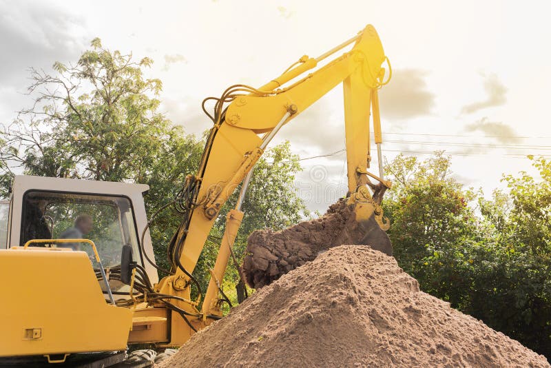 A Bulldozer Excavator is Digging on Outdoors in an Industrial Site ...