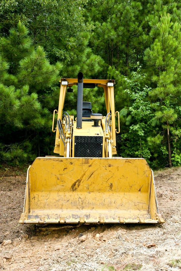 Bulldozer in Front of Pines Stock Photo - Image of mover, trees: 11168534