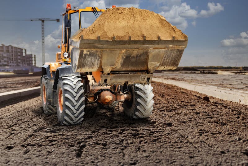 Bulldozer or Loader Moving Sand on a Construction Site during the ...