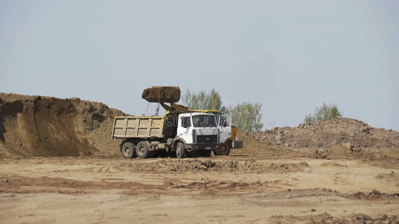 Bulldozer Loading Sand Transportation Truck on Construction Site ...