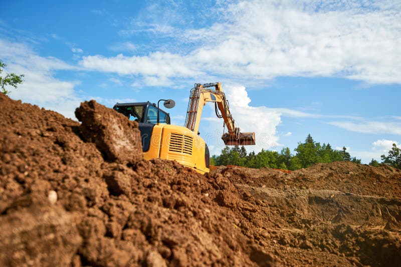 Excavator at Construction Site - Digging Foundations for House Stock ...