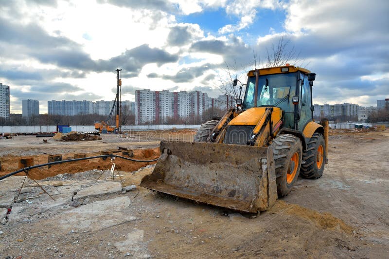 Bulldozer and Pile Driving Machine on a Construction Site Stock Photo ...