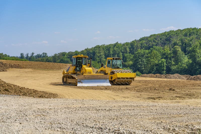 Bulldozer and Roller Compactor Stock Photo - Image of site, compactor ...