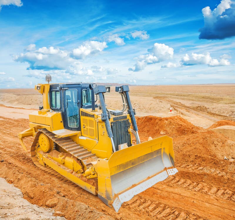 Bulldozer on sand in field stock photo. Image of metal - 49158536