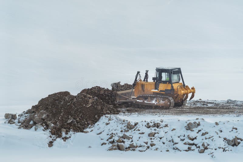 Bulldozer Working on Road Construction Site in Grading Phase in Winter ...