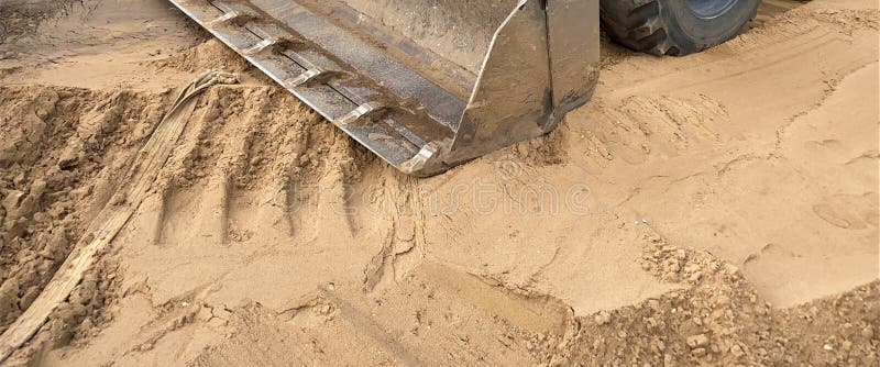Bulldozer Working on Sand in the Construction Site. Wheel Loader at ...