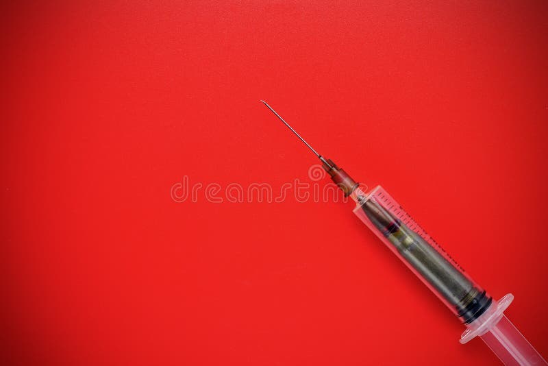 Bullet in a Disposable Syringe on a Red Background Stock Image - Image ...