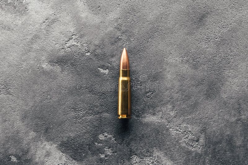 Bullet on gray background stock image. Image of ammunition - 244915235