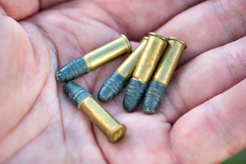 Bullet in the hand stock photo. Image of hold, bullets - 96886150