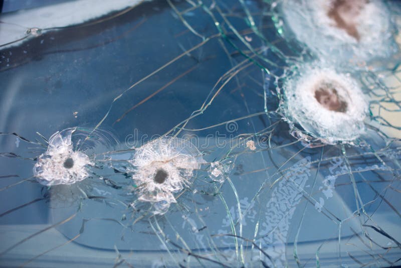 Bullet Hole on a Car Windshield. Car Window after a Raid Has a Bullet ...